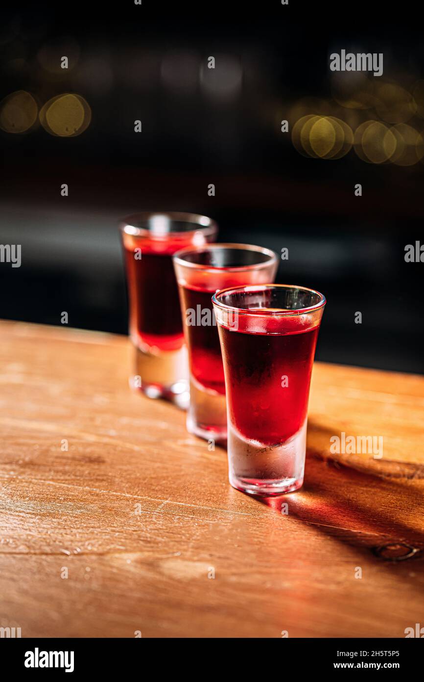 Various shot drinks on the wooden bar desk Stock Photo - Alamy