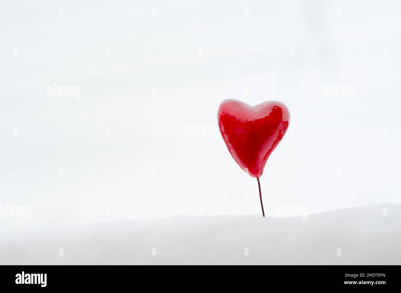 Small red heart on a stick in a snowdrift Stock Photo - Alamy