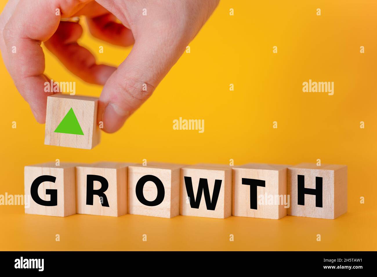 The word grow on wooden cubes on a yellow background. The concept of ...