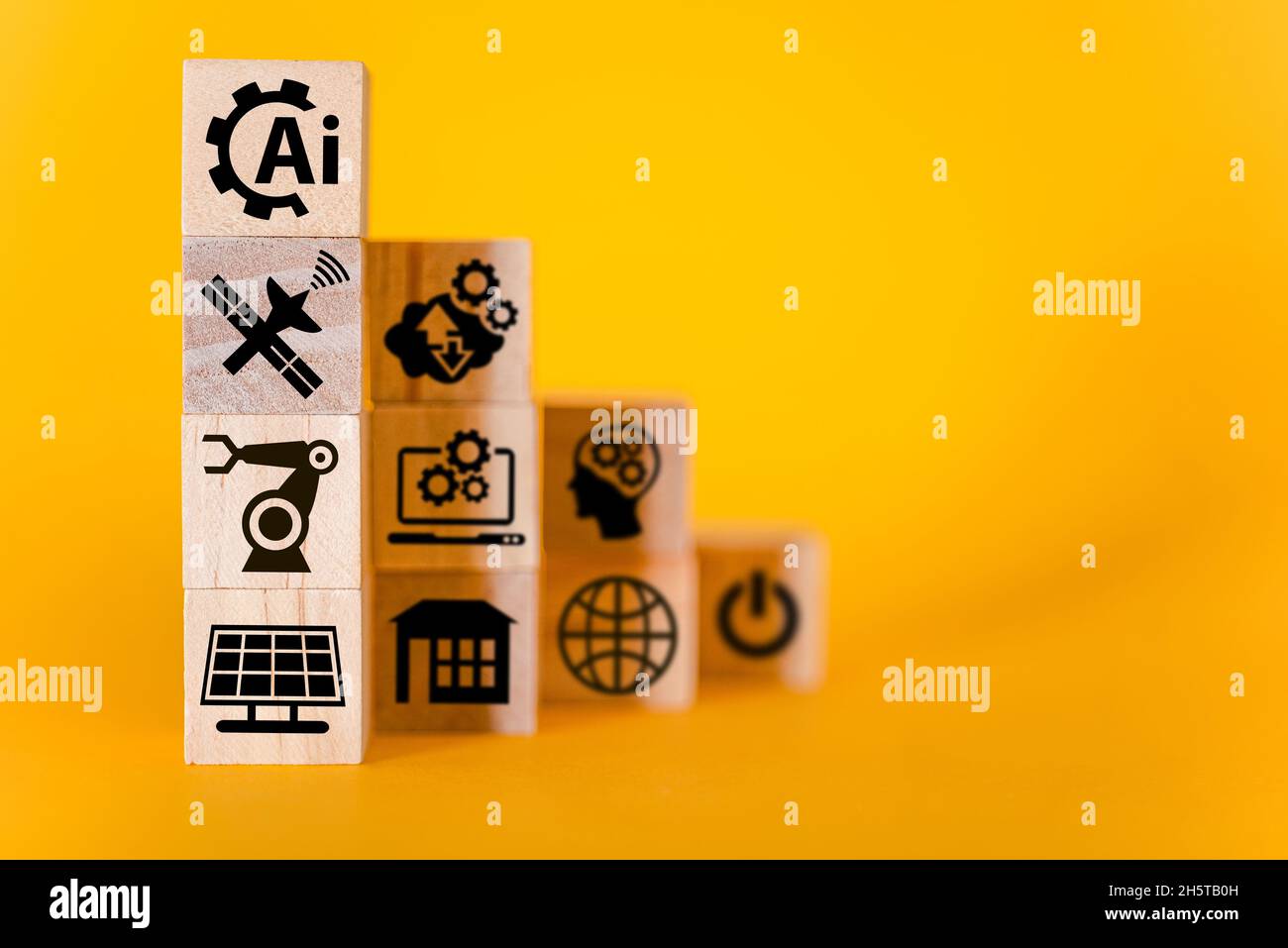 Artificial intelligence signs on wooden cubes, yellow background. The ...