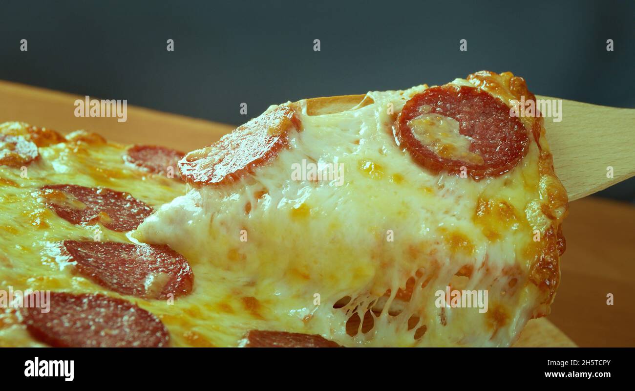 homemade pizza Pepperoni .taking slice of pizza,melted cheese dripping ...