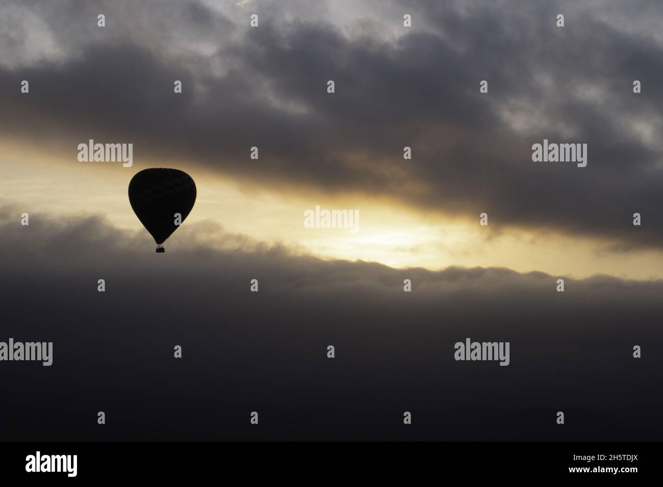 Silhouette of a single parachute against dark dramatic cloudy sky Stock ...