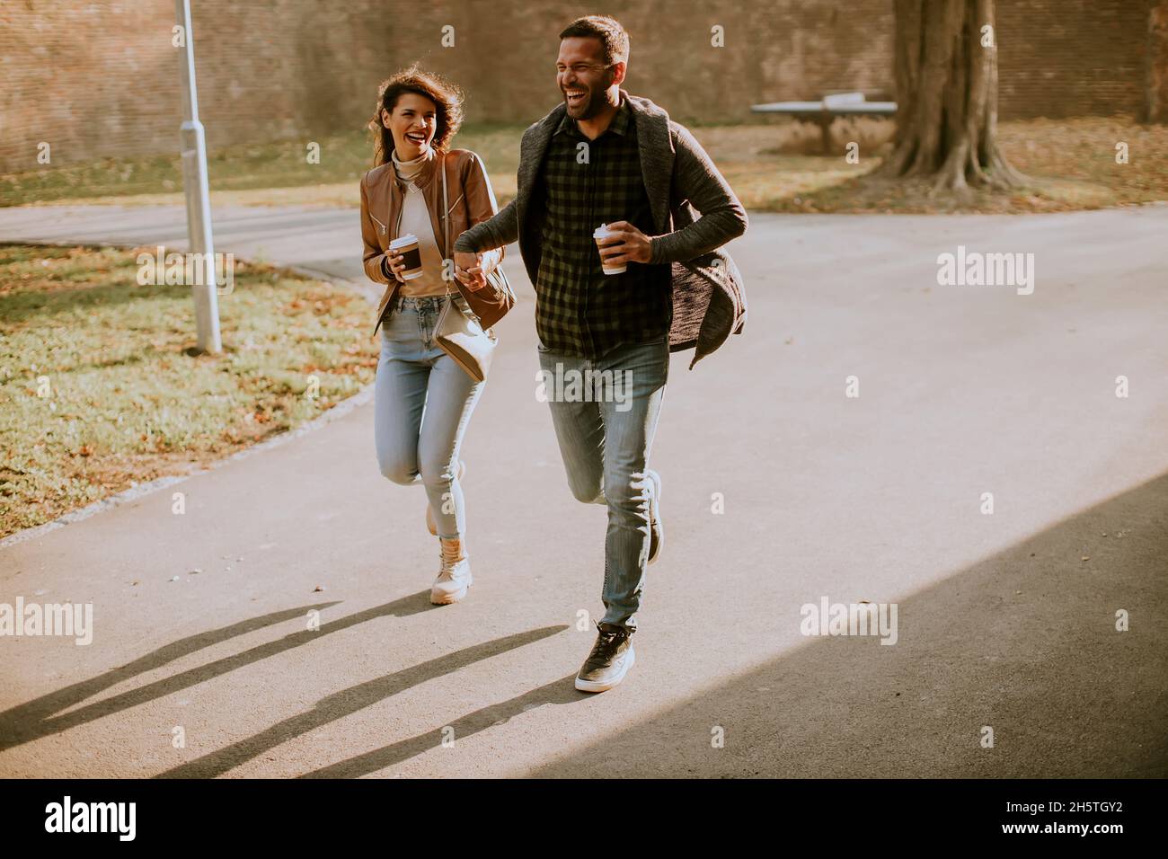 Romantic couple running together in hi-res stock photography and images ...