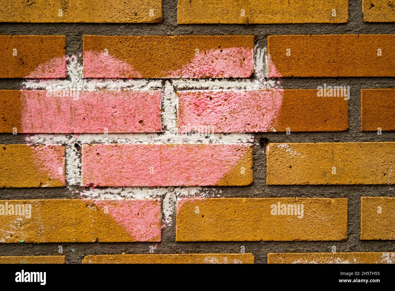 Heart shadow on a brick wall texture Stock Photo - Alamy