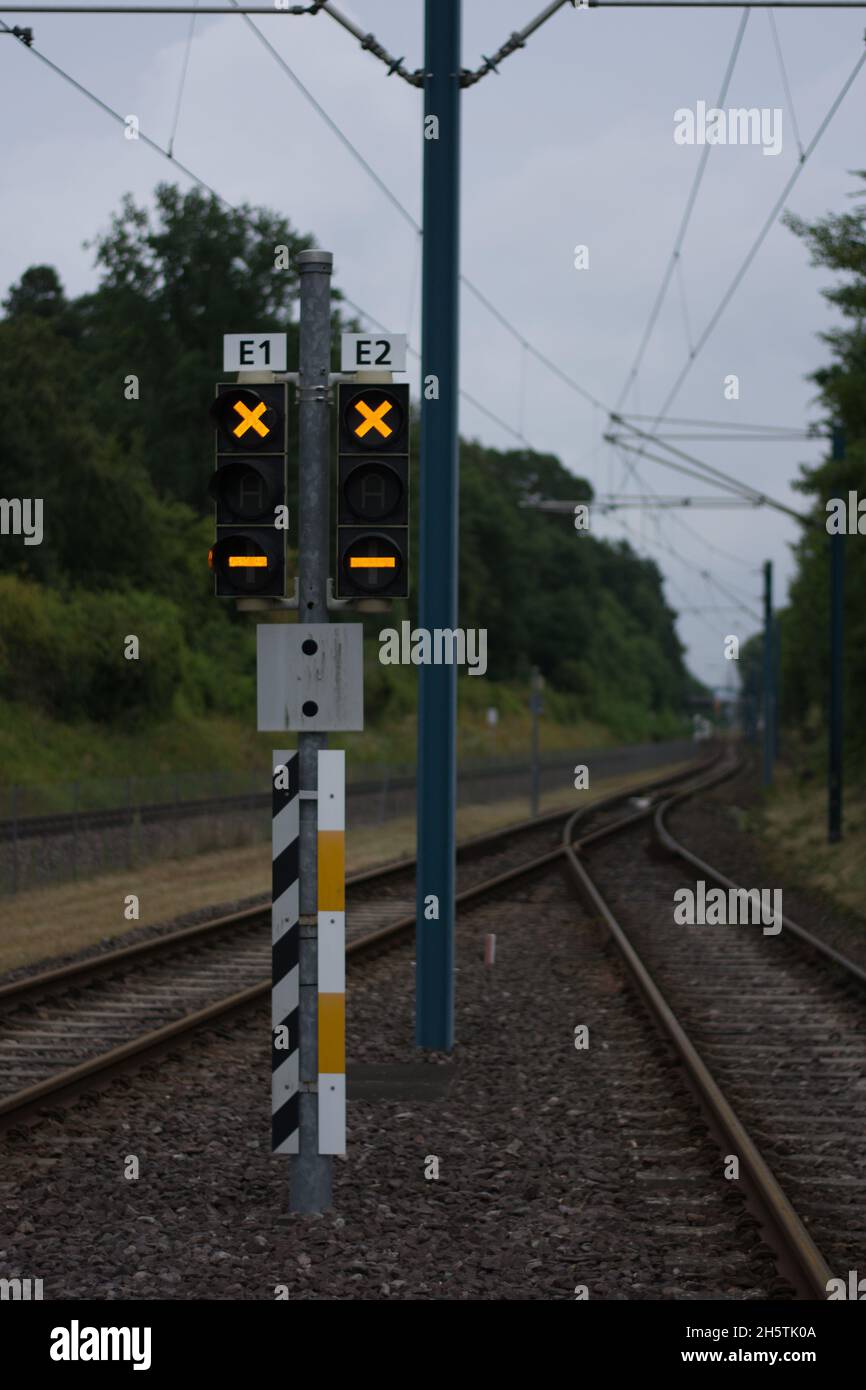 Vertical closeup of two yellow stop signs at the train railway Stock ...