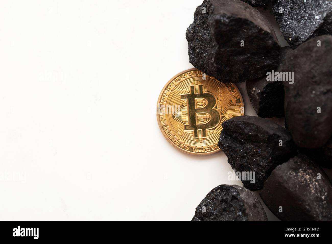 Bitcoin mining concept. Gold bitcoin cryptocurrency coin with lumps of ...