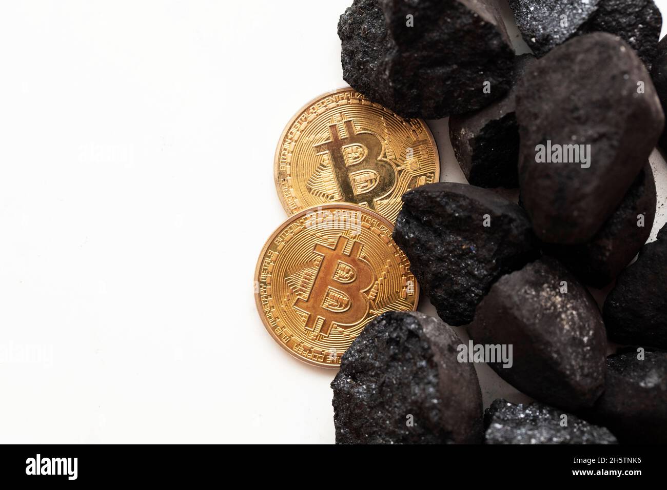 Bitcoin mining concept. Gold bitcoin cryptocurrency coin with lumps of ...