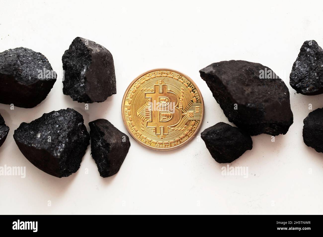 Bitcoin mining concept. Gold bitcoin cryptocurrency coin with lumps of ...