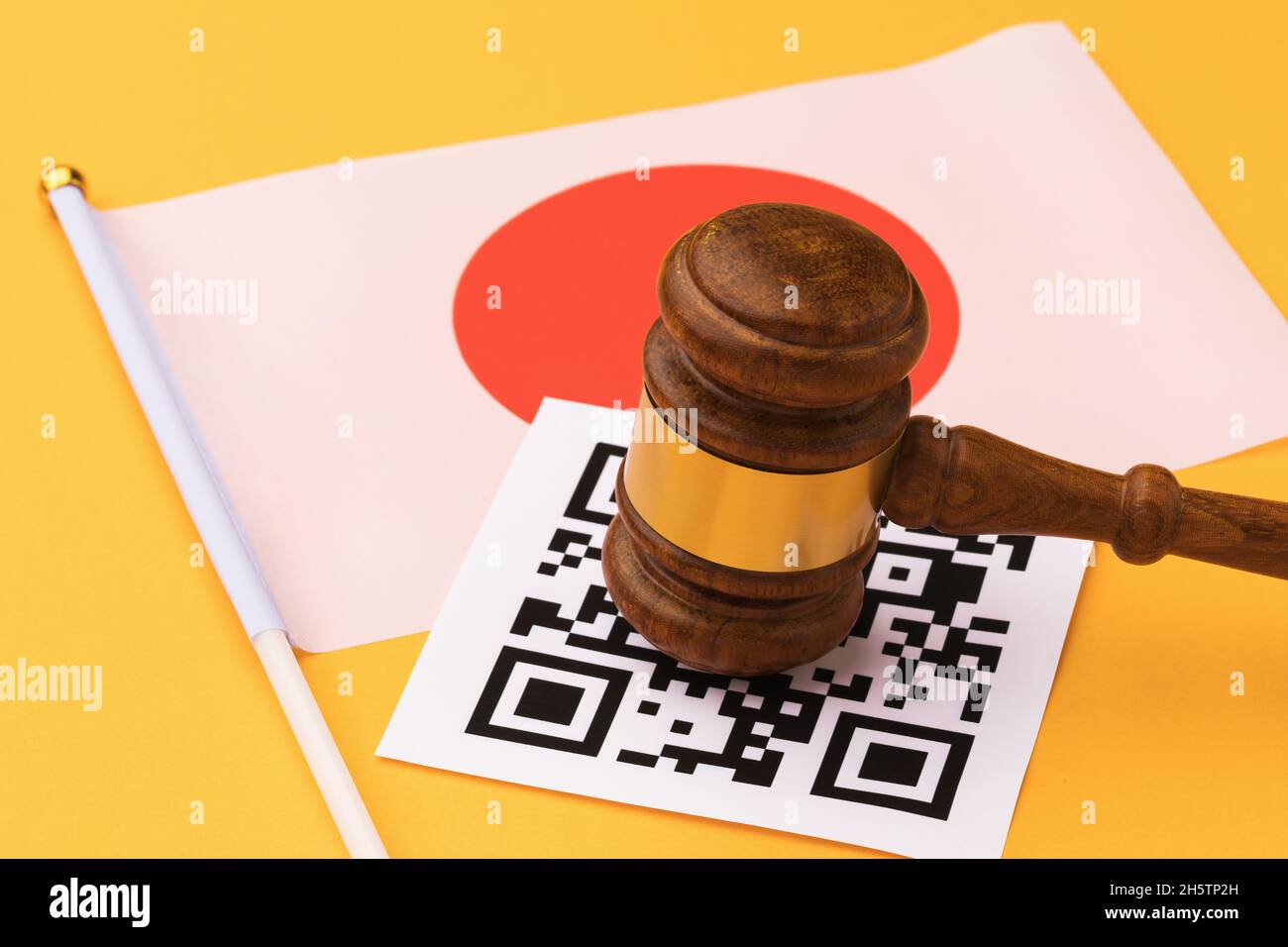 Judge gavel, barcode sheet and the flag of Japan on a yellow background ...