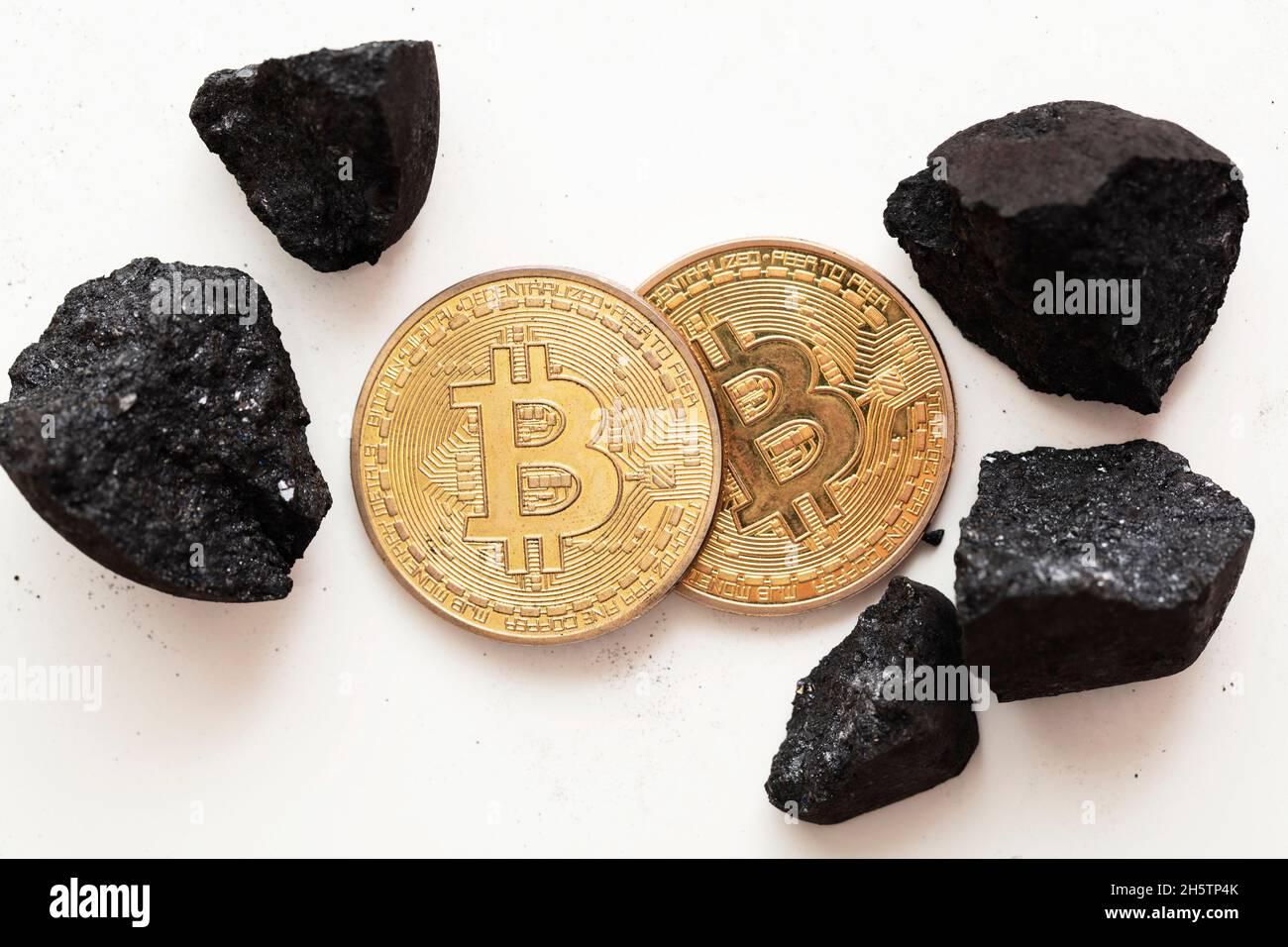 Bitcoin mining concept. Gold bitcoin cryptocurrency coin with lumps of ...