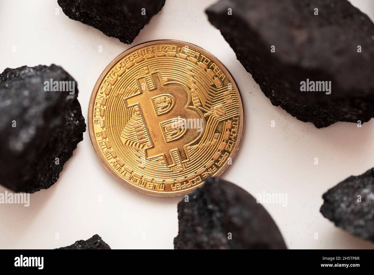 Bitcoin mining concept. Gold bitcoin cryptocurrency coin with lumps of ...