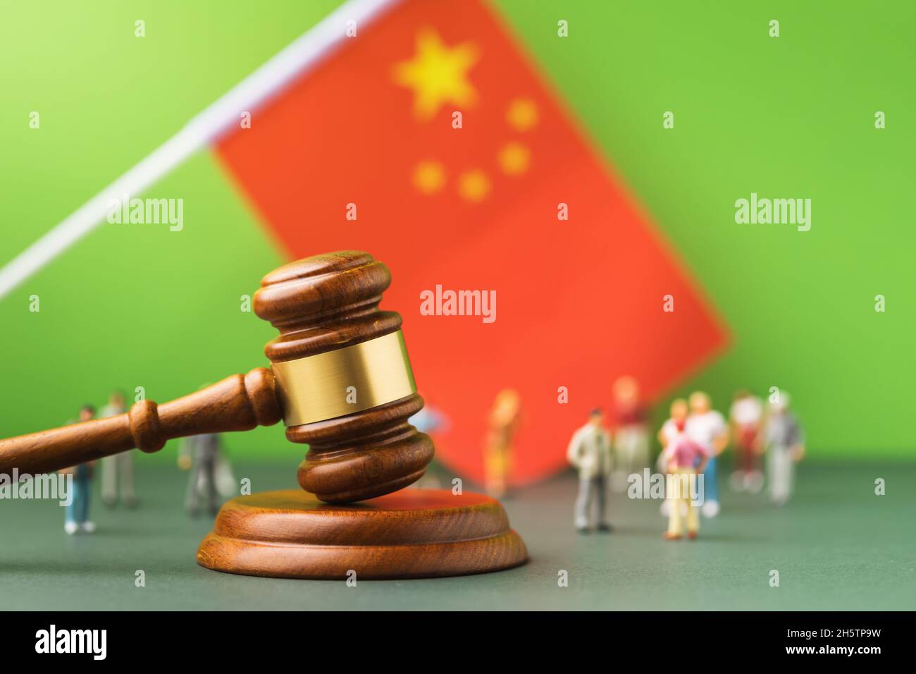 Judge gavel against blurry flag background and toy plastic men, concept ...