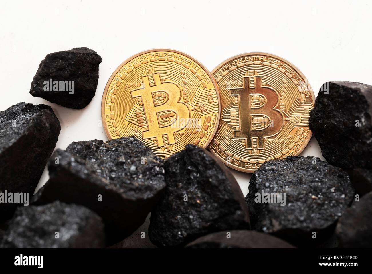 Bitcoin mining concept. Gold bitcoin cryptocurrency coin with lumps of ...