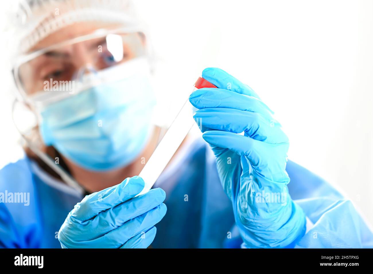 female doctor examines a test tube with tests. Medical concept. Blood ...