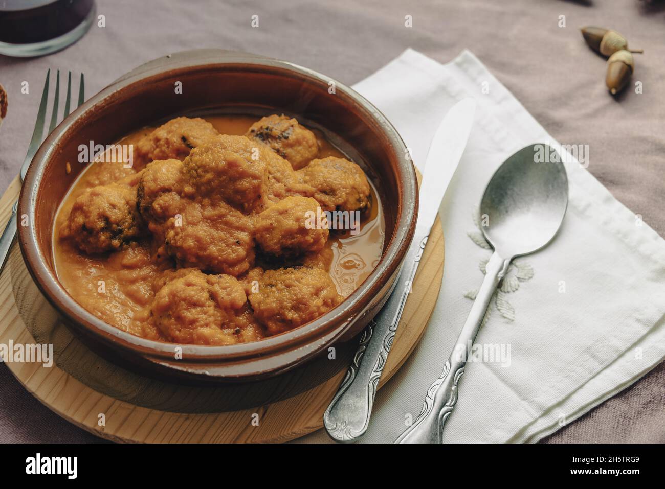Rustic plate of meatballs in tomato sauce set on a tablecloth Stock ...