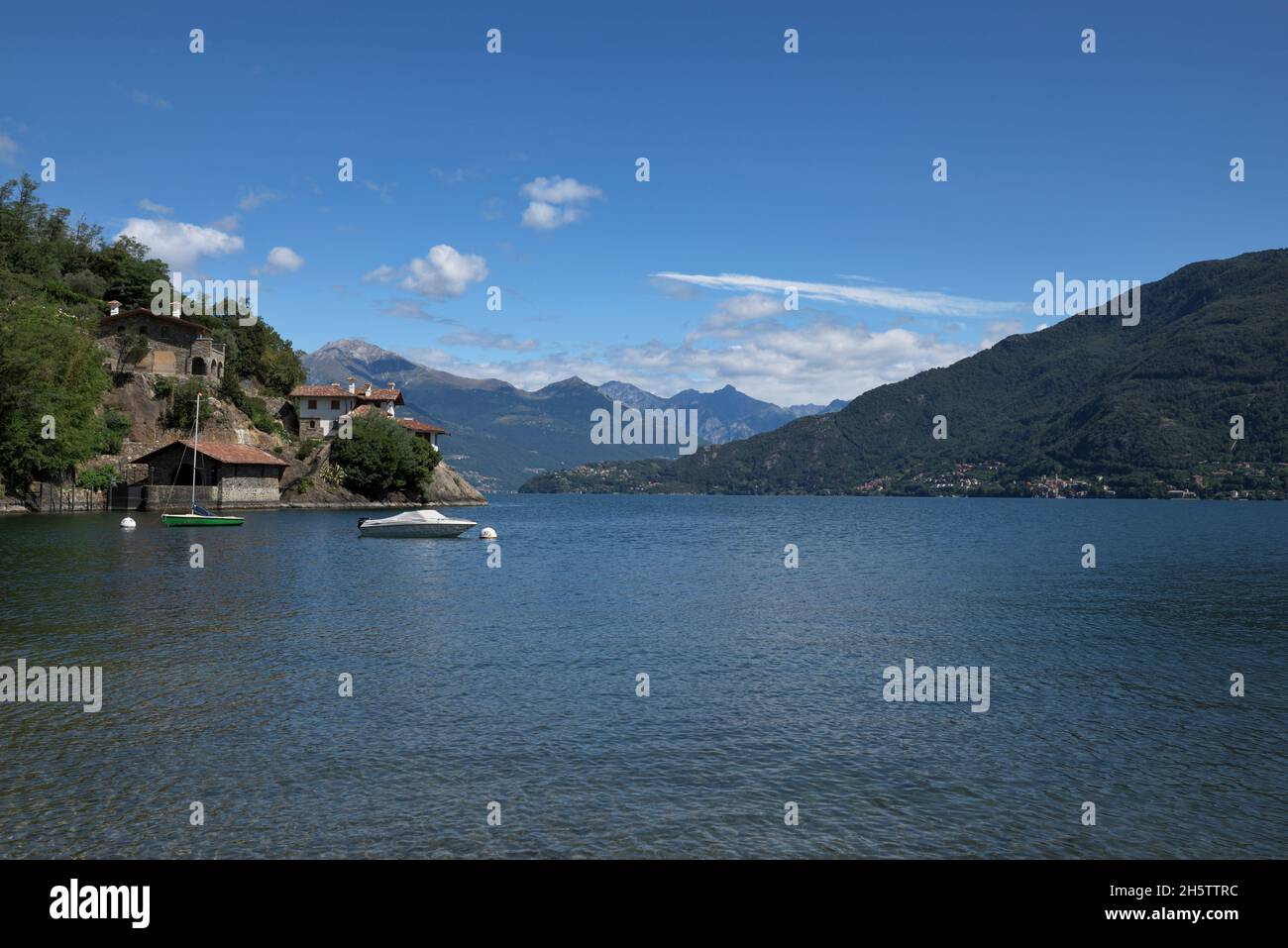 Small bay with boats and rustico stone houses at Lake Como, Italy Stock ...
