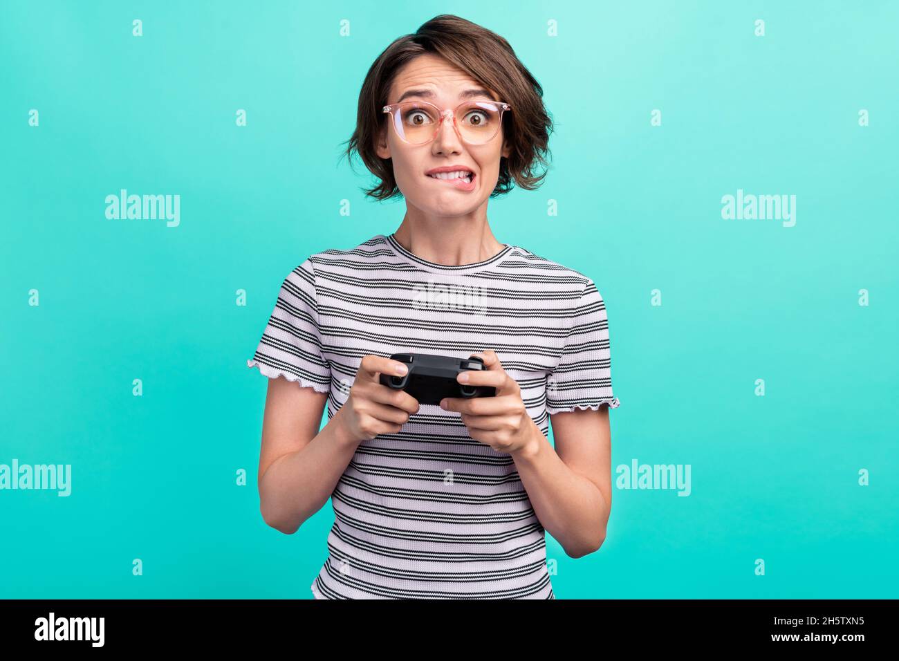 Photo of young girl bite lips teeth worried addicted play video game ...