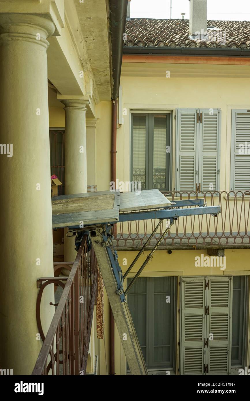 Vertical shot of a messy house balcony in the process of moving in/out ...