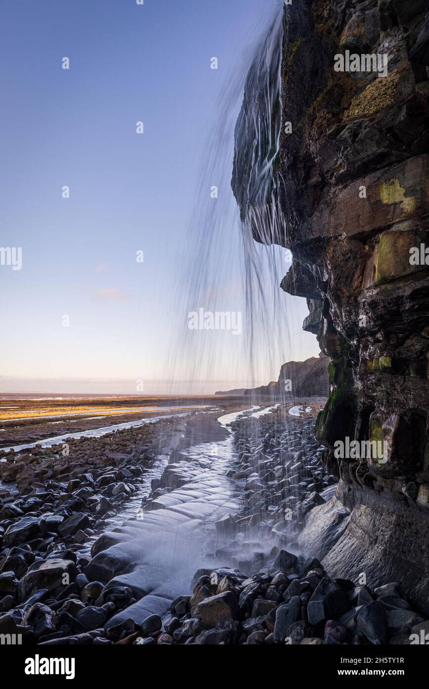 Cliffs and rock strata visible at low tide on the beach at East ...