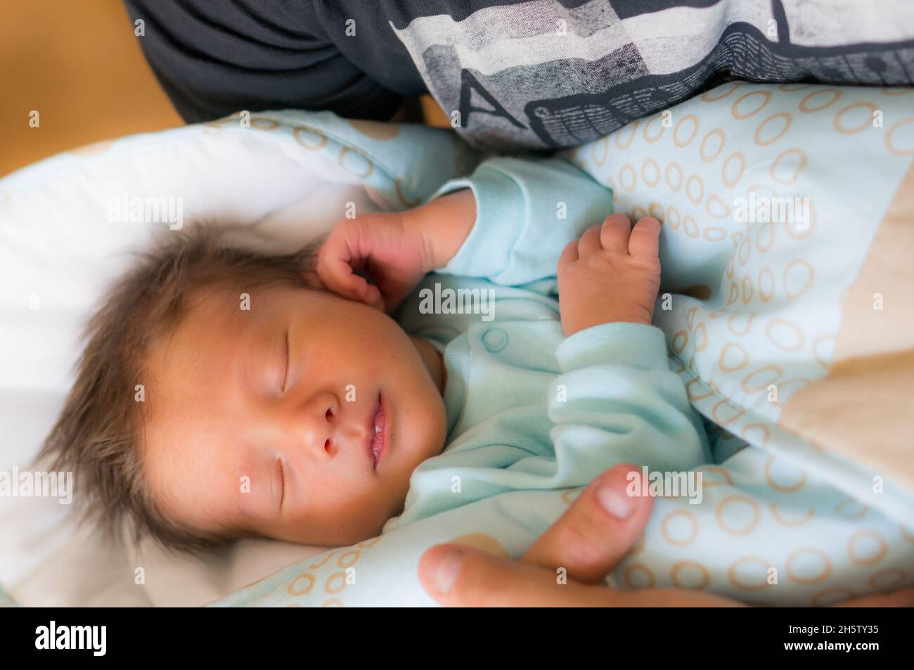 Portrait of a cute little Polish baby sleeping on father's arms Stock ...