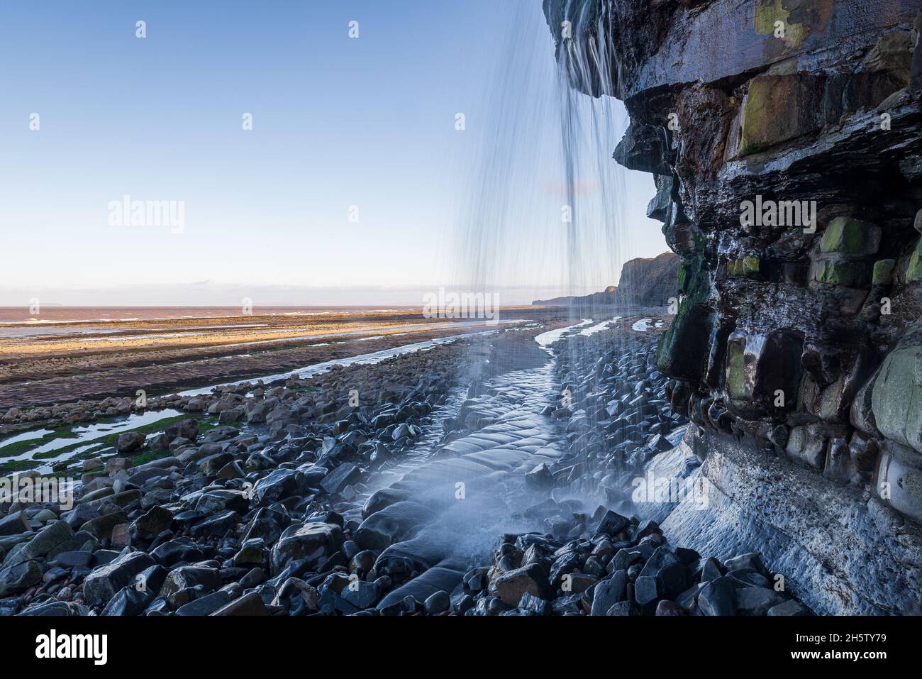 Cliffs and rock strata visible at low tide on the beach at East ...