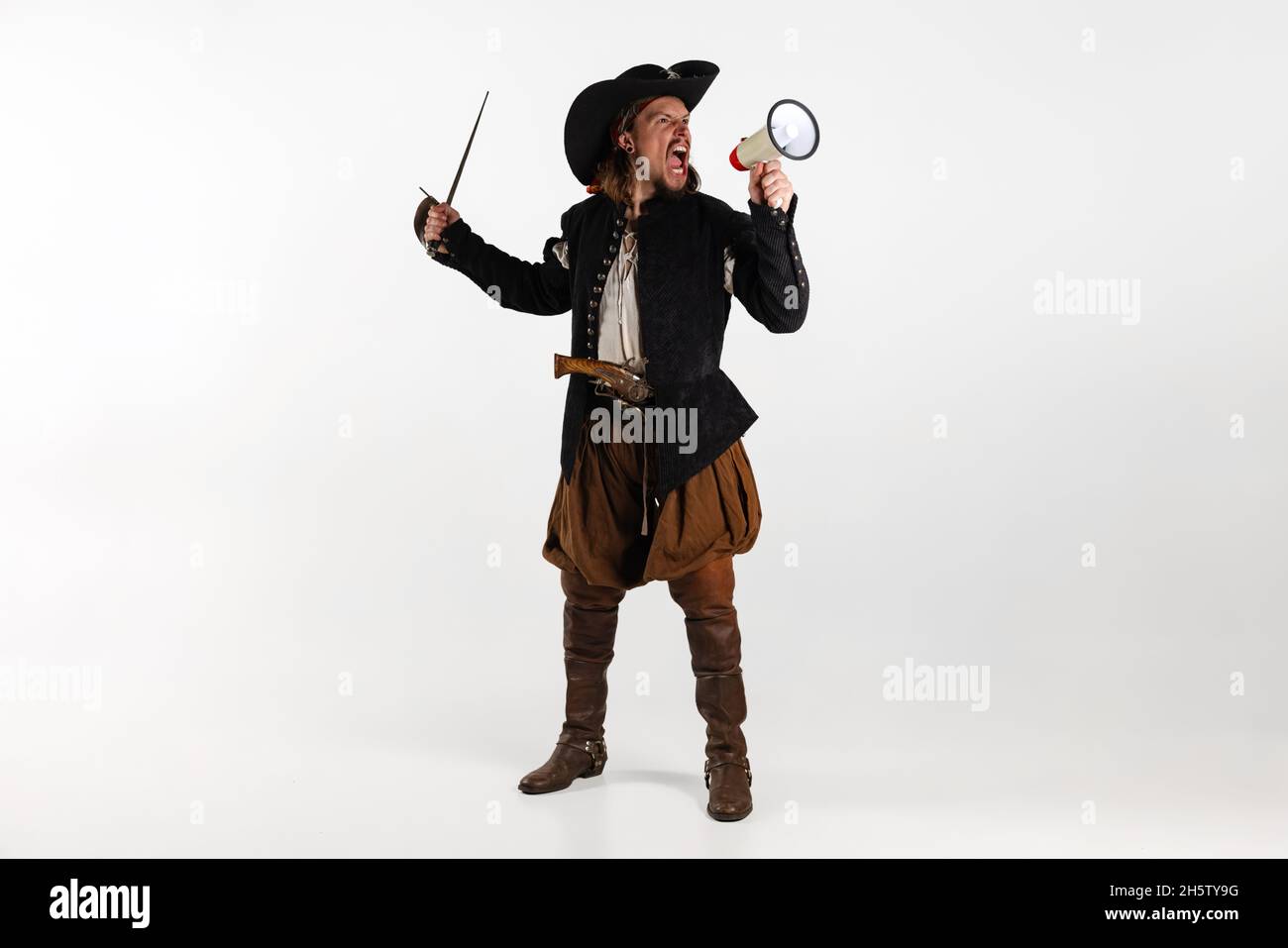 Full-length portrait of man, pirate in vintage costume raising sword ...