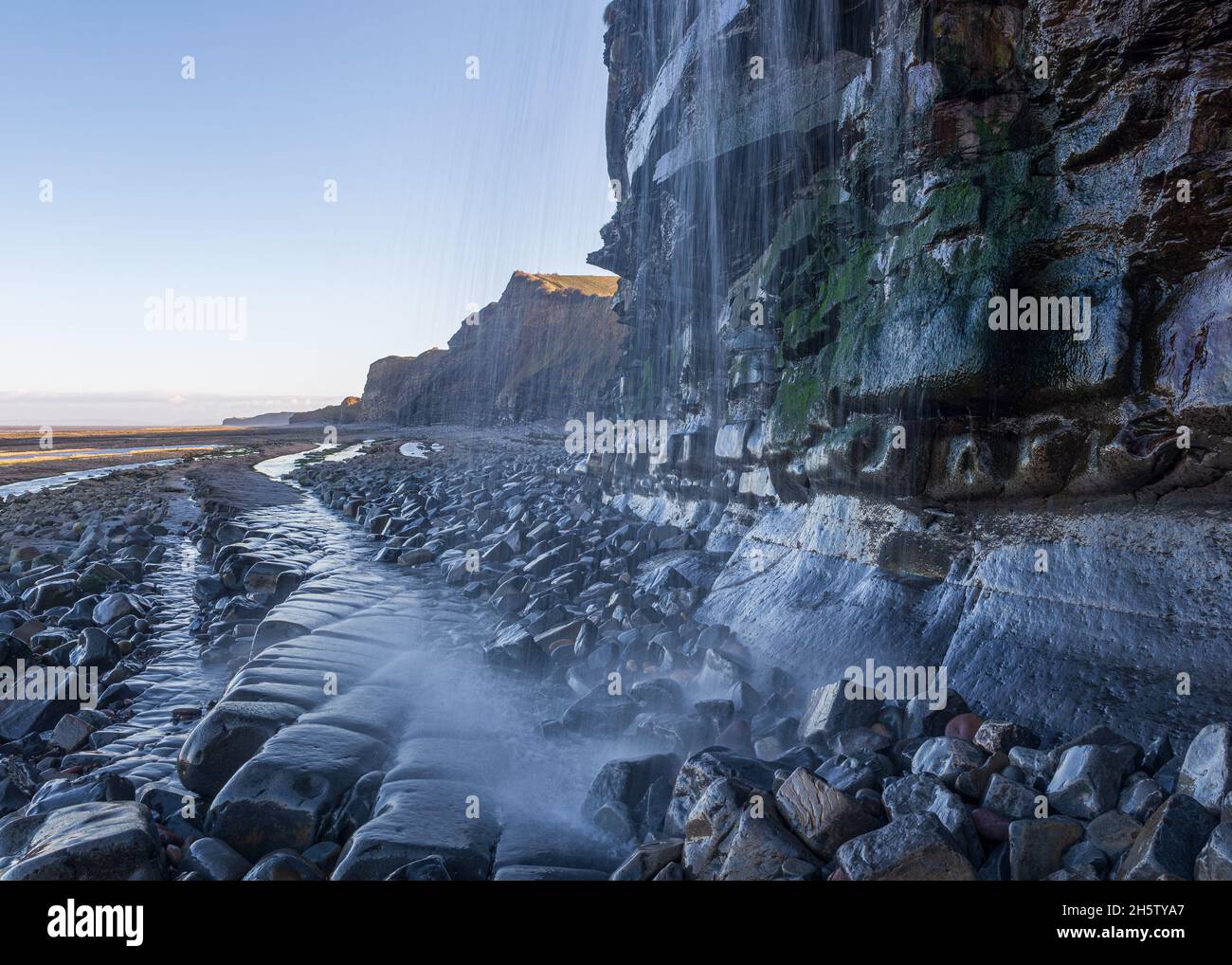 Cliffs and rock strata visible at low tide on the beach at East ...