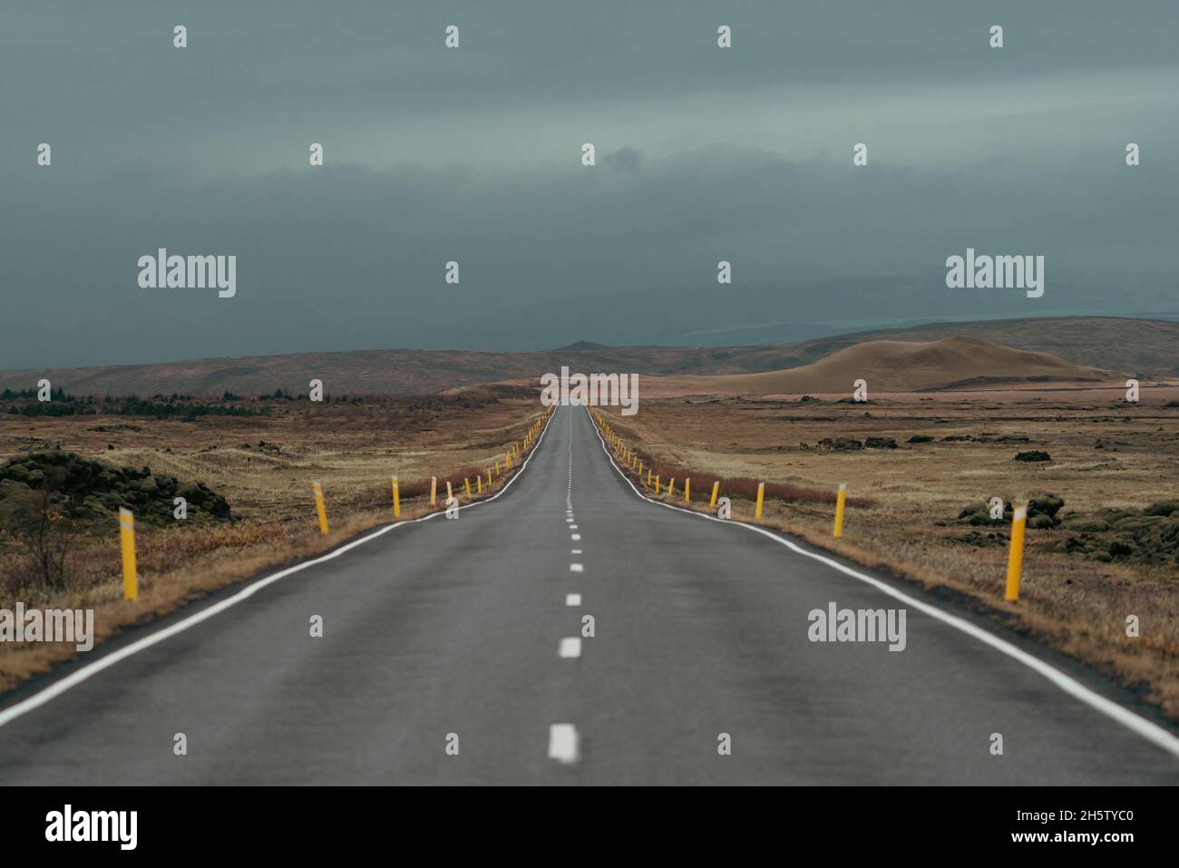 Empty straight road under the clouds for text space Stock Photo - Alamy