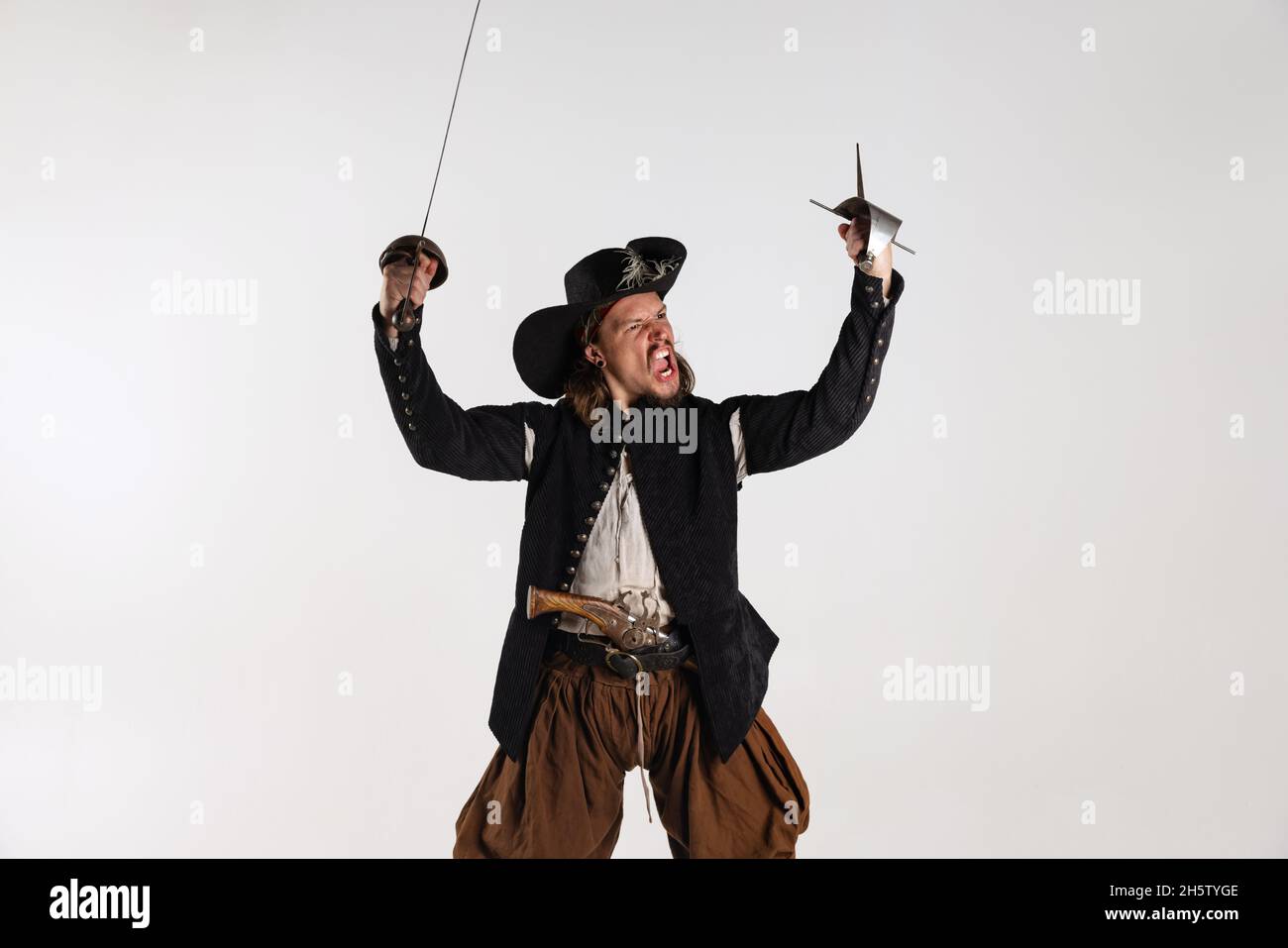 Portrait of brutal, frightening man, pirate in vintage costume raising ...