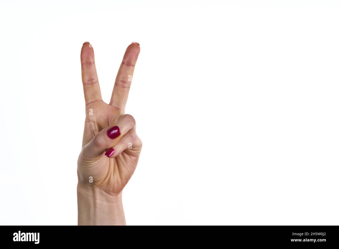 Hand with two fingers up in the peace or victory symbol. Also the sign ...