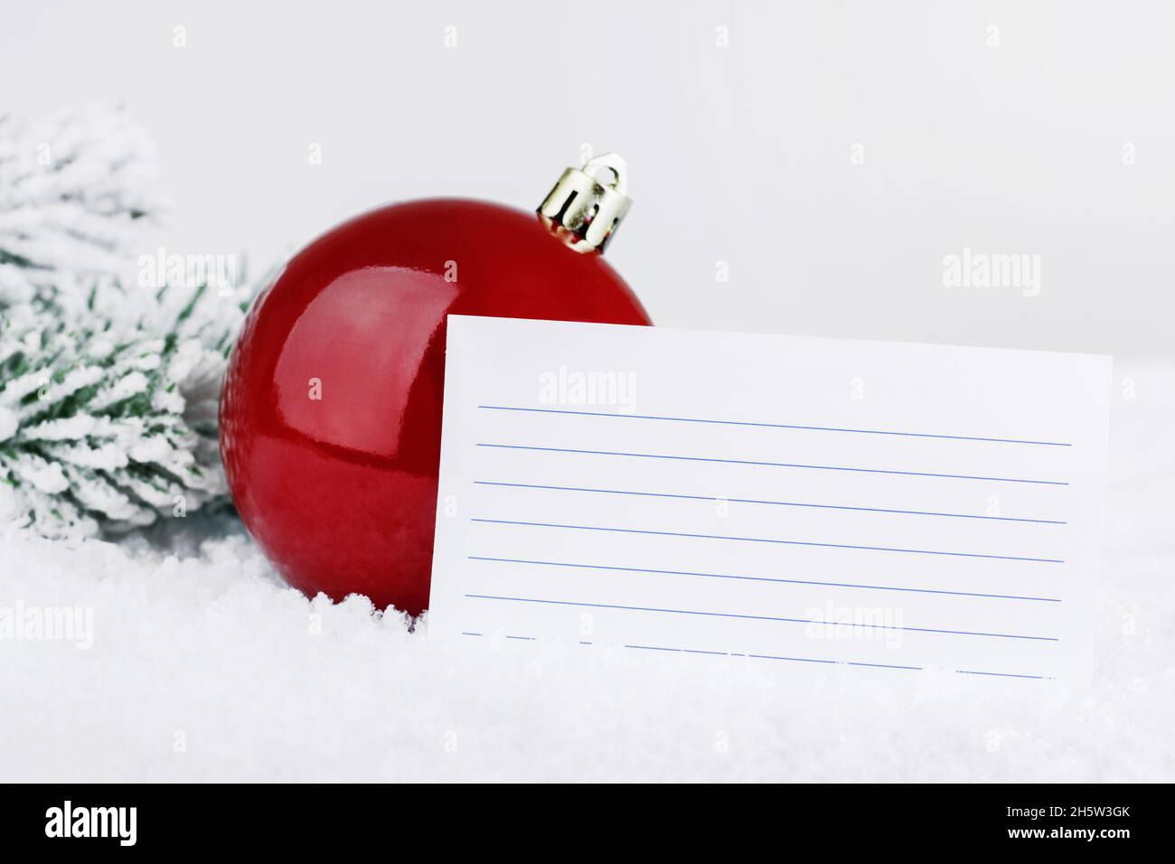 White sheet in a ruler, on the snow, near the New Year's toys a red ...