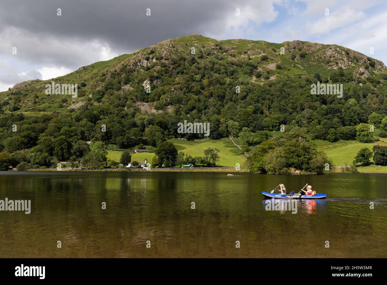 Lake District tourists; visitors canoeing on Rydal Water lake in summer ...
