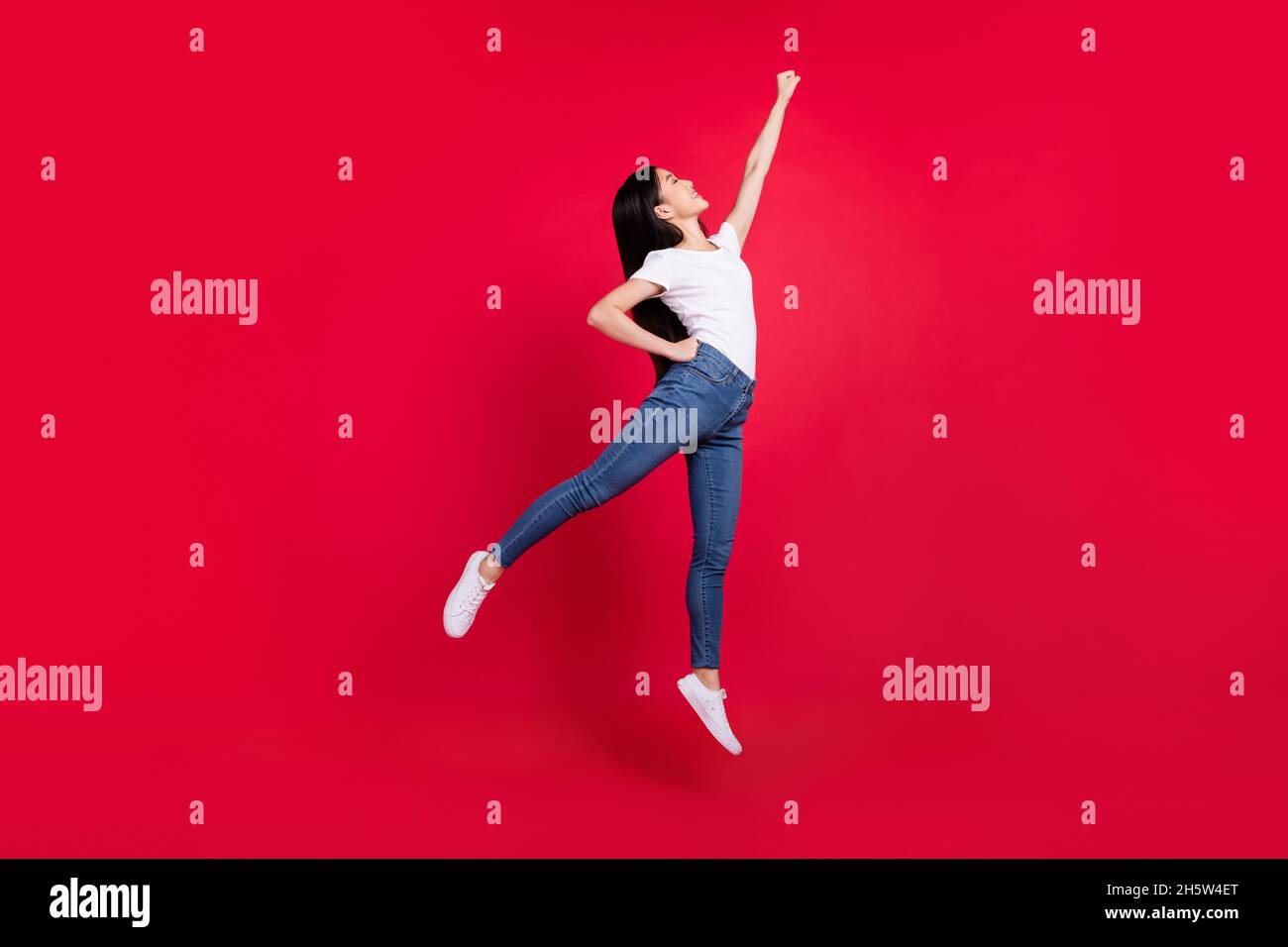 Full body photo of young korean girl power strong jump fly superwoman ...