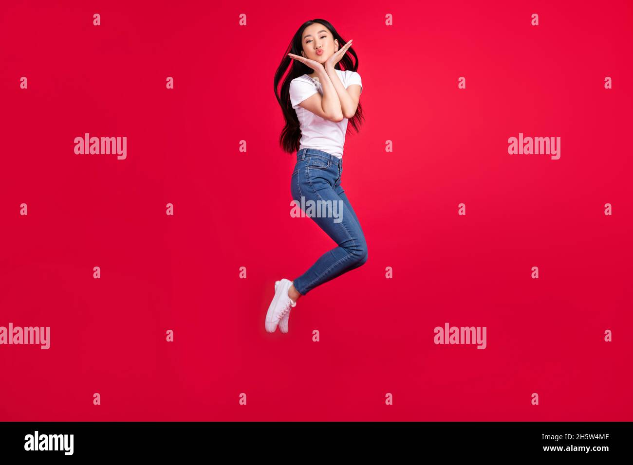 Photo of romantic affectionate lady jump blow air kiss wear white t ...