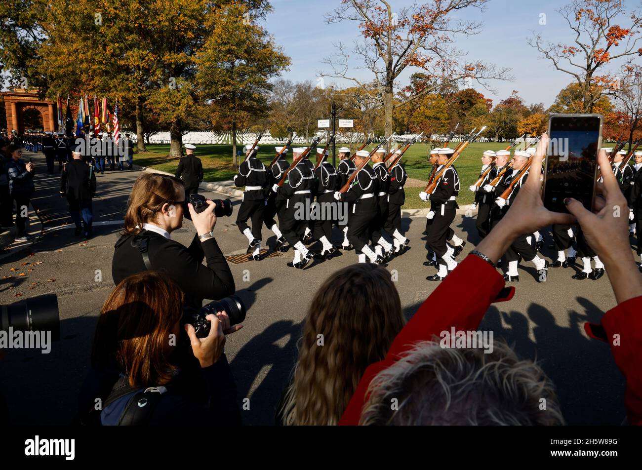 People take pictures as United States troops march during a joint full ...