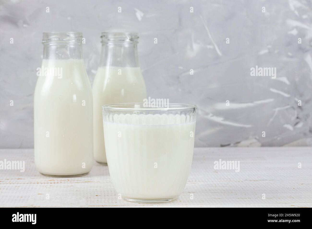 Delicious fresh milk on a gray wooden background. A glass of fresh milk ...