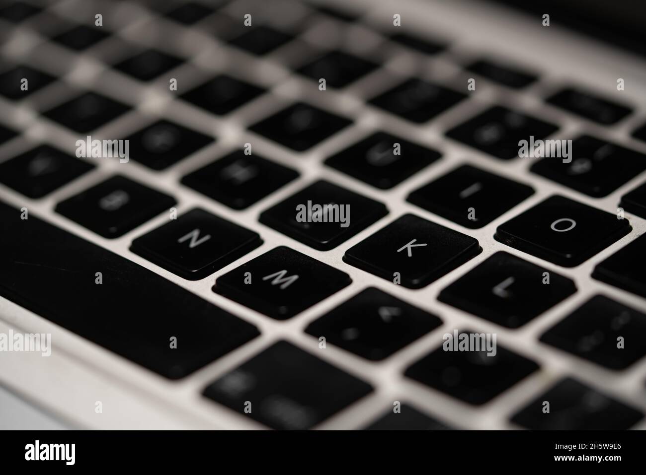photo of a black qwerty keyboard on a silver background Stock Photo - Alamy