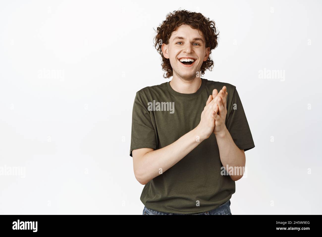 Happy young man laughing and applause, clapping hands and smiling ...