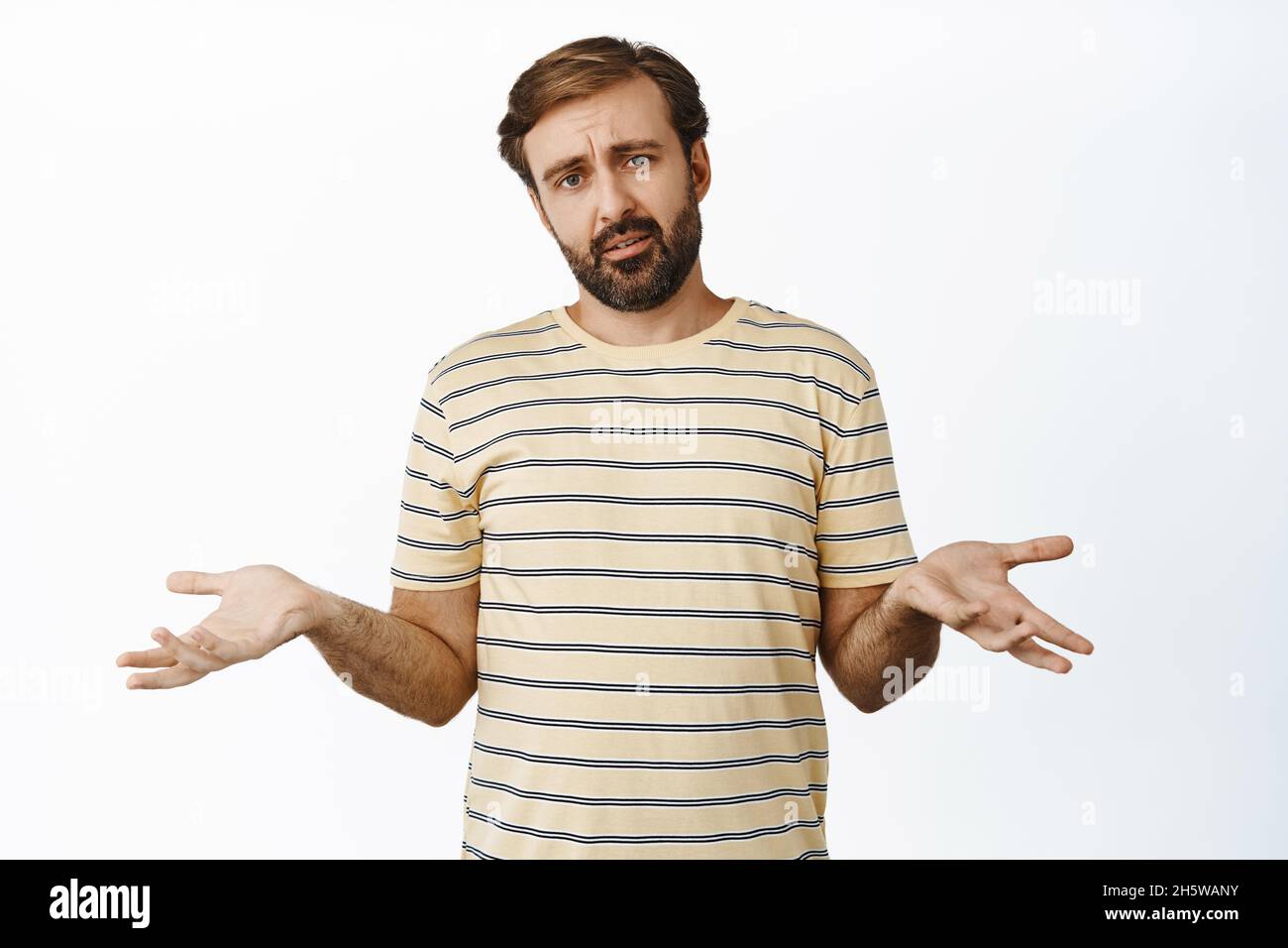 Sad and confused guy with beard, shrugging, showing empty hands ...