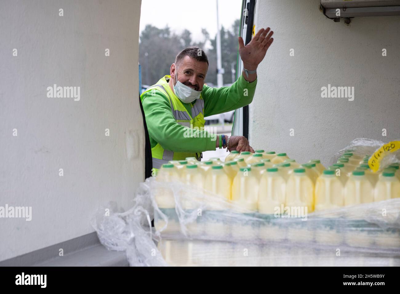 A volunteer delivering surplus milk at the London community kitchen ...