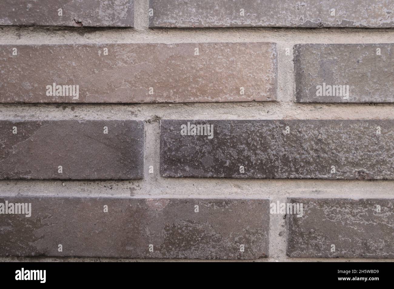 Detail of a wall made of facing bricks on the outside that form small ...