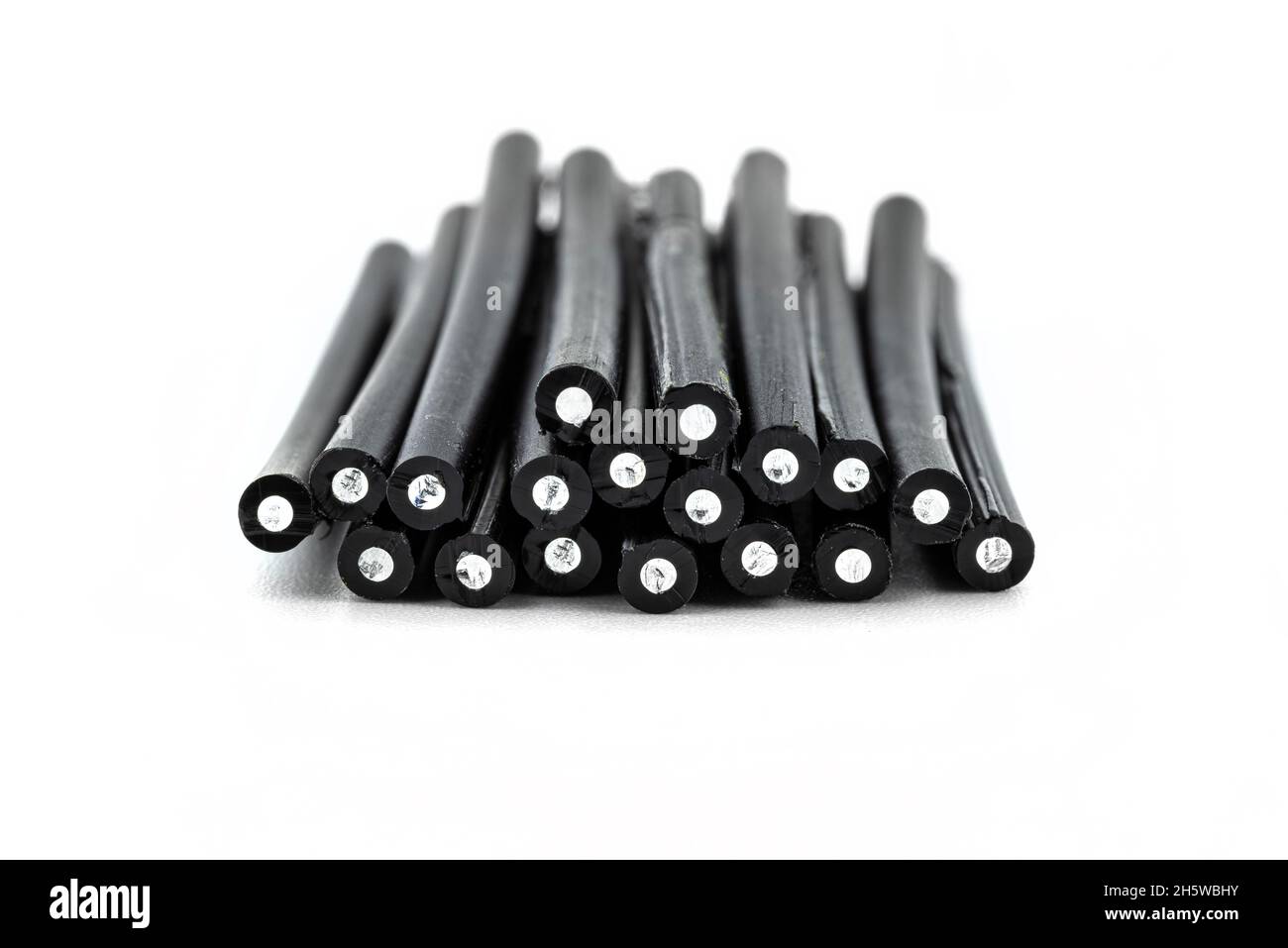 A stack of cut fiber optic cables lying on top of each other, isolated ...