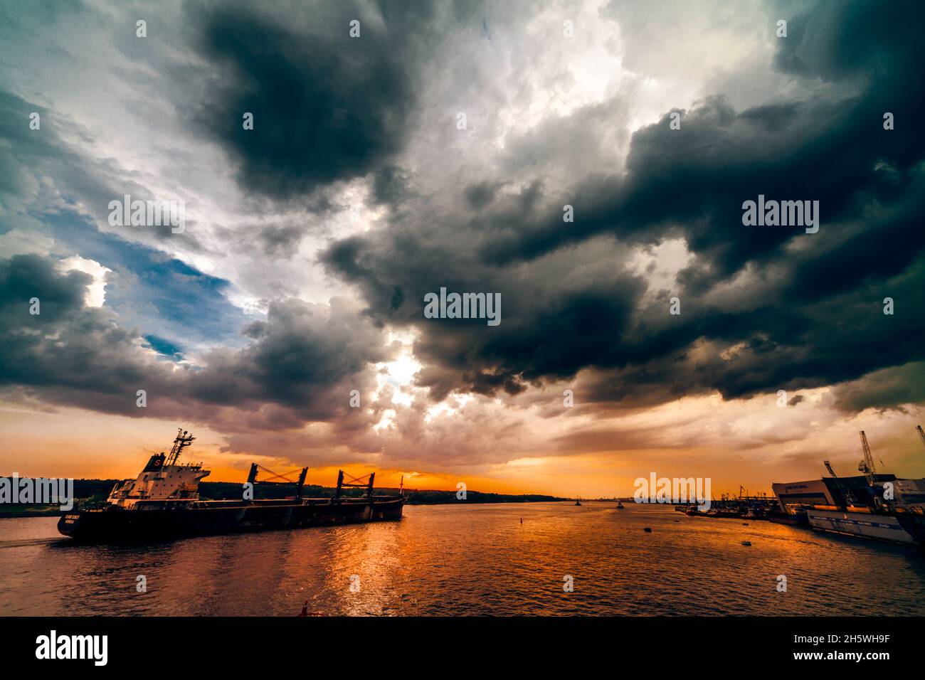 Beautiful sunset view of the port aquatory and ships sailing. Klaipeda ...
