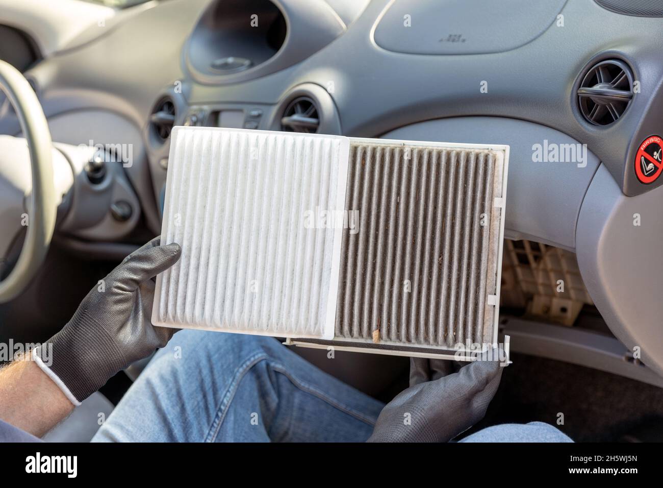 Replacing the dirty cabin pollen air filter for a car Stock Photo - Alamy