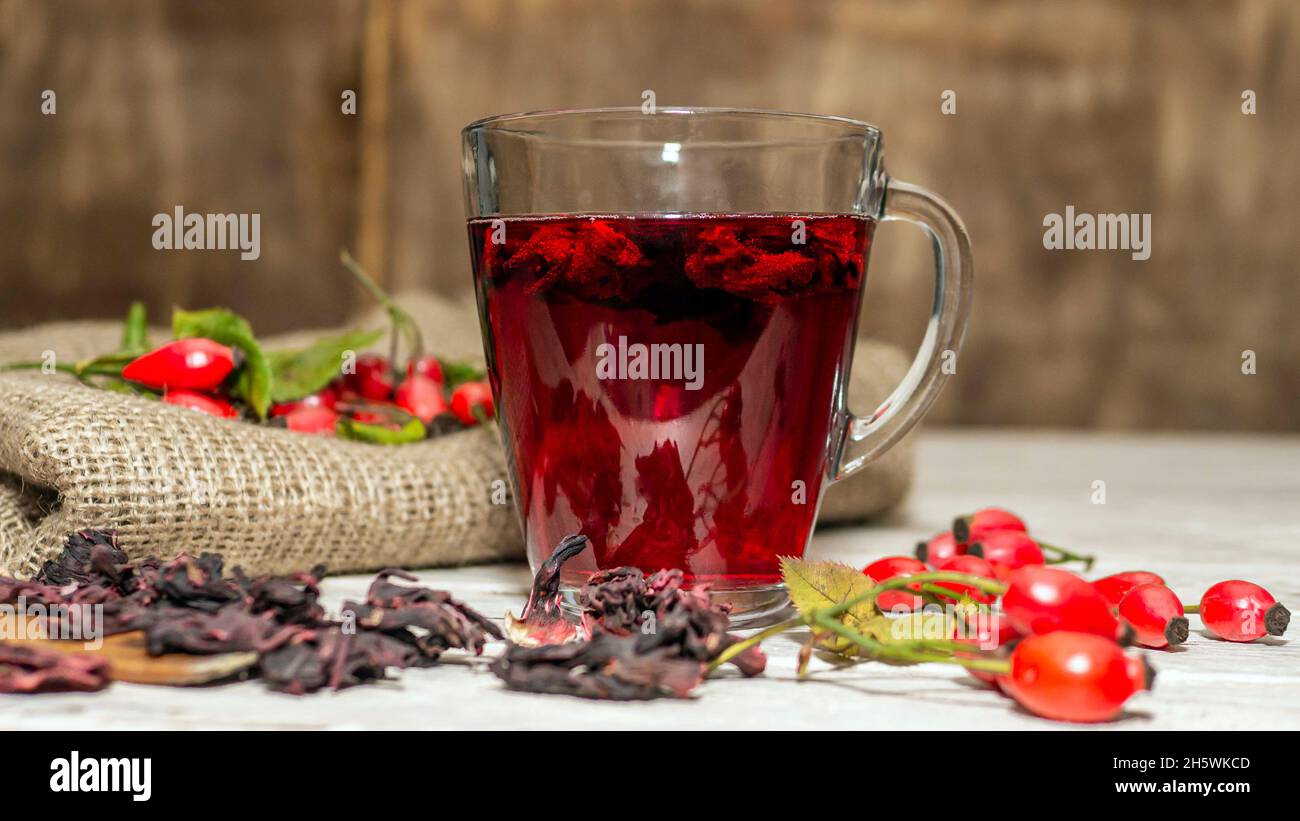 Natural tea from wild rose berries on wooden boards. Homeopathy ...