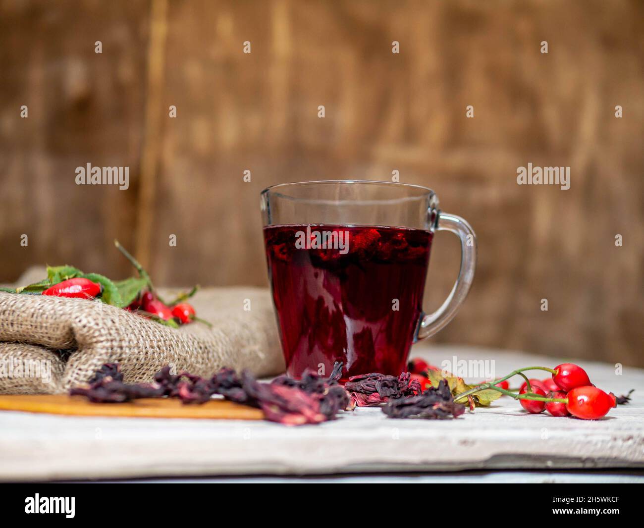 Natural tea from wild rose berries on wooden boards. Homeopathy ...