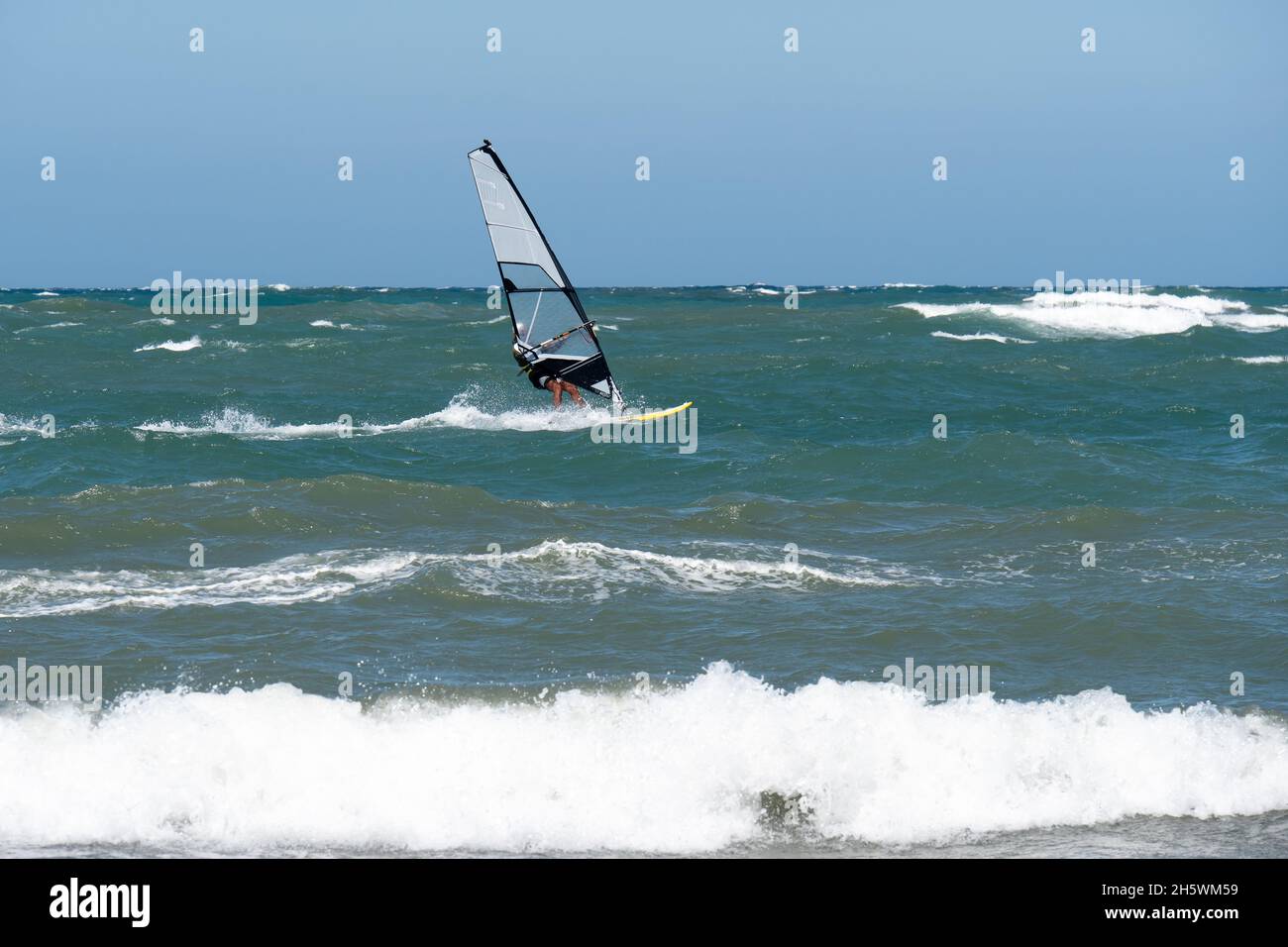 Windsurf Riding the Waves in a Choppy Sea Stock Photo - Alamy