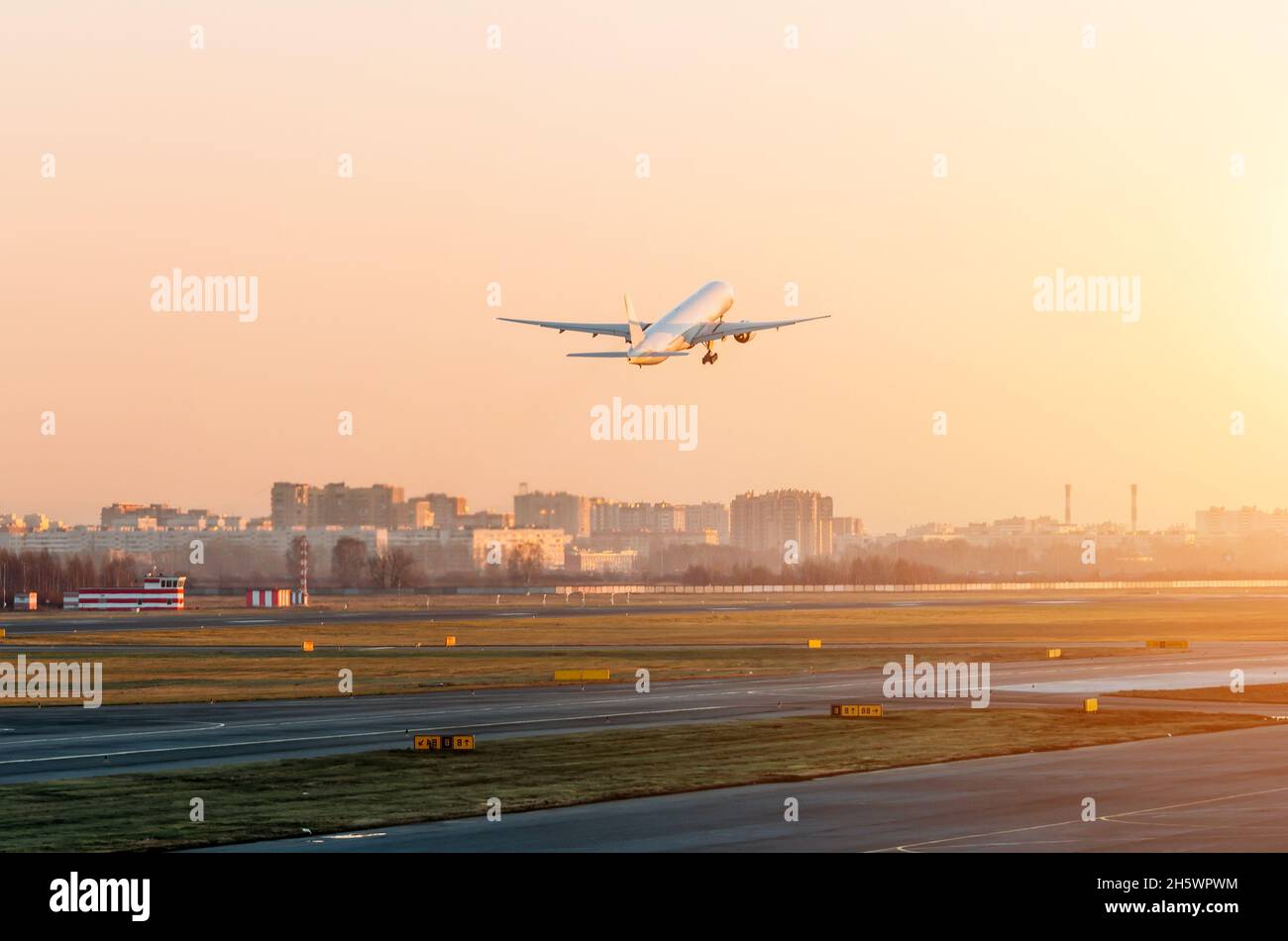 Passenger plane taking off in the sky sunset airport Stock Photo - Alamy