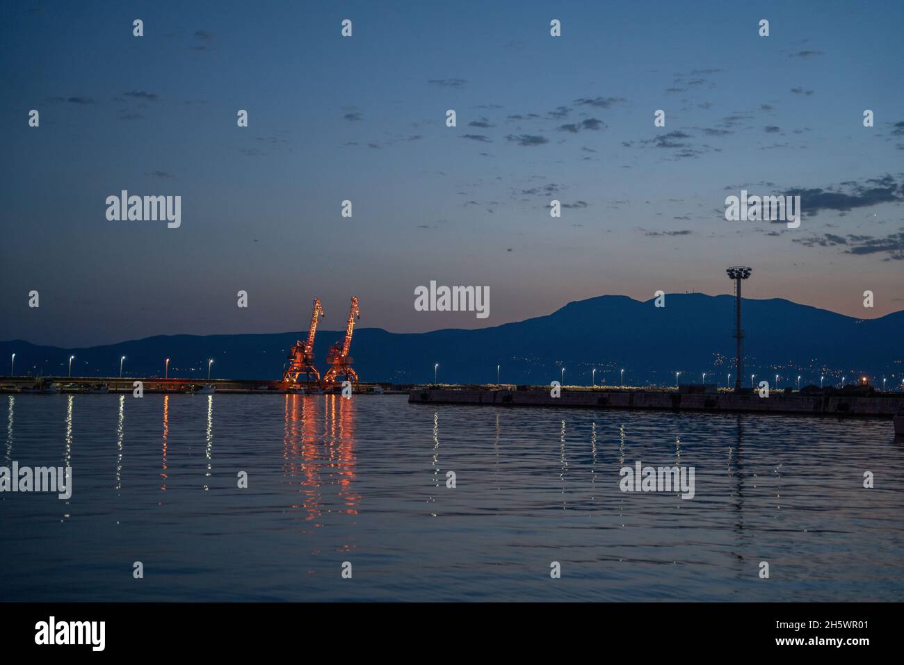 Landscape of the Port of Rijeka surrounded by mountains in the evening ...