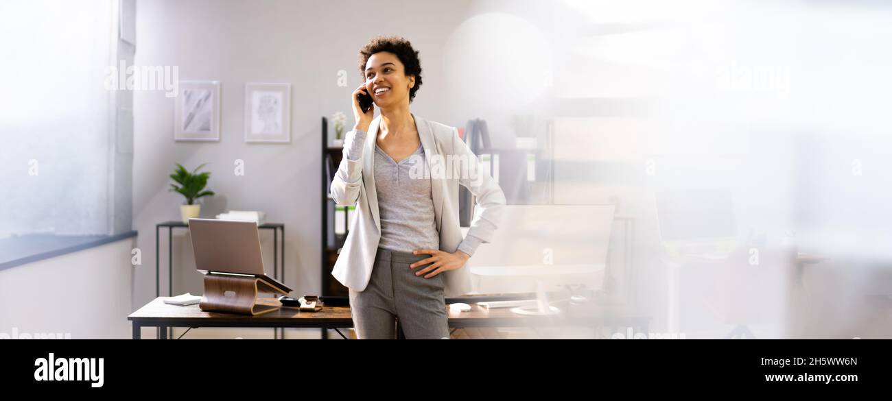 African Business Woman Making Phone Call In Office Stock Photo - Alamy